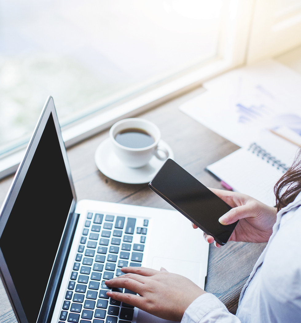 Businesswomen using mobile phone and laptop in office – Trapp Technology